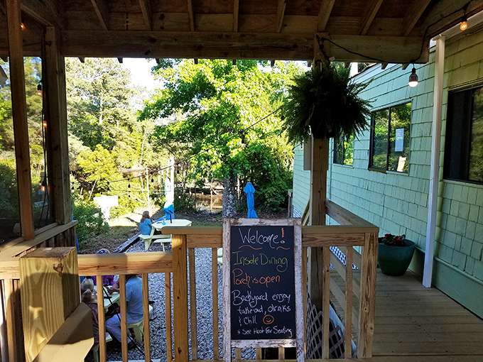 The outdoor seating area welcomes with casual charm. That chalkboard isn't just a menu—it's a promise of good things to come.