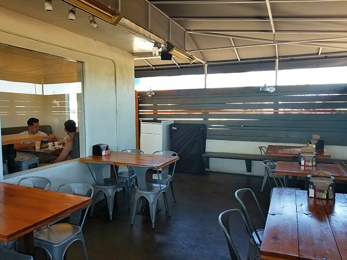 The outdoor seating area offers a perfect spot to contemplate the meaning of life, which, after biting into their burgers, seems suspiciously connected to perfectly grilled beef.