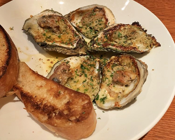 Oysters that look like they're still daydreaming about the sea. Perfectly broiled with a buttery topping that makes you want to order another round immediately.