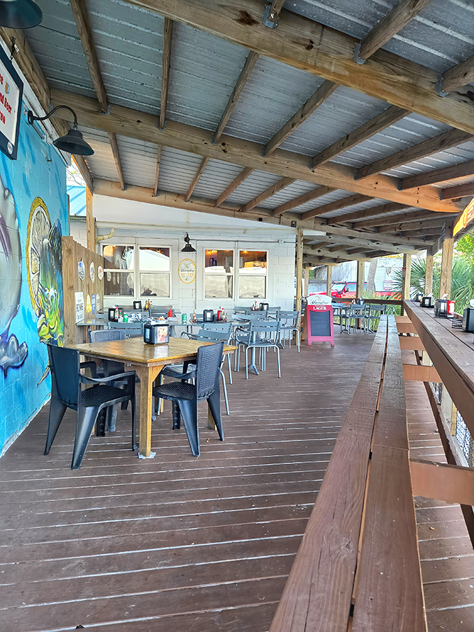 The covered patio offers rustic charm and breathing room. Simple wooden tables where unforgettable meals and conversations happen daily.