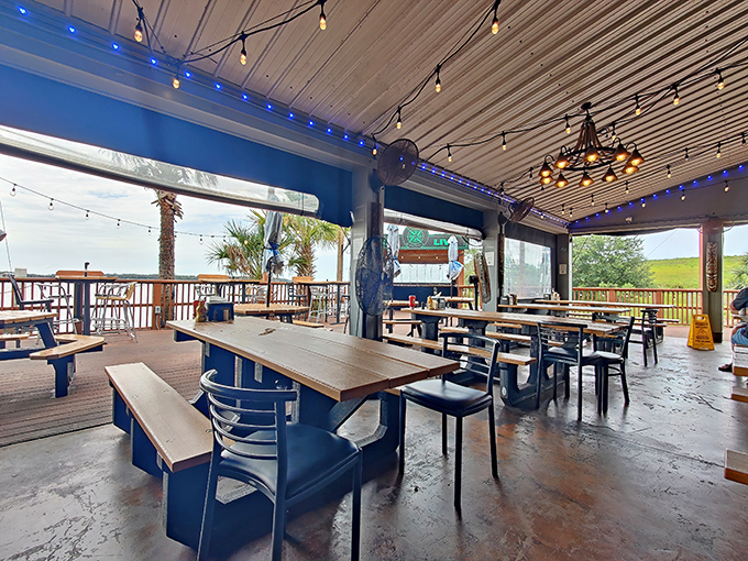 Outdoor dining with string lights and water views. Even the most ordinary Tuesday feels like a special occasion under this covered patio.