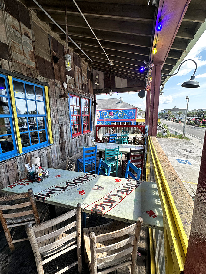 Outdoor seating with weathered tables and colorful chairs offers ocean breezes with your seafood feast&mdash;nature's perfect dining companion.