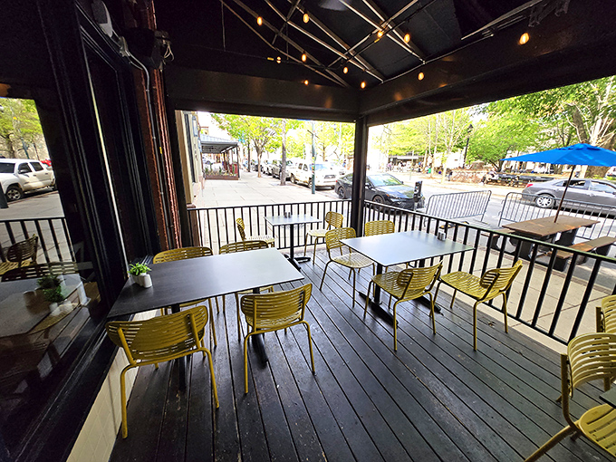 Outdoor seating that lets you people-watch while you biscuit-watch&mdash;a perfect Asheville afternoon in bright yellow chairs.
