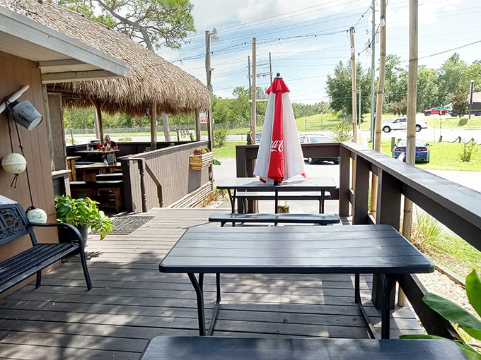 The outdoor seating area offers the quintessential Florida dining experience: fresh air, casual vibes, and the lingering question of whether that's a gator in the distance.