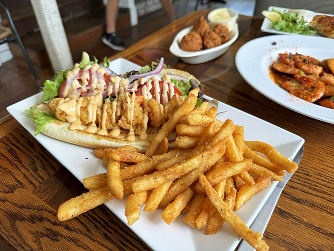 This isn't just a sandwich, it's architectural genius &ndash; crispy seafood, perfect bread, and fries that make you question your lifelong potato allegiances.