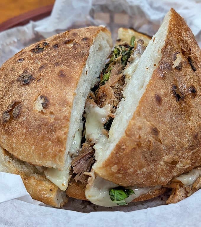 This porchetta sandwich isn't playing around. The bread is merely a delivery system for that glorious meat and melted cheese situation.