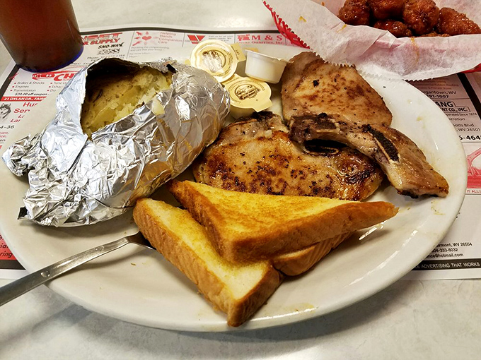 Pork chops that have clearly been introduced to fire with proper respect, served alongside toast that's ready to soak up every last bit of flavor.