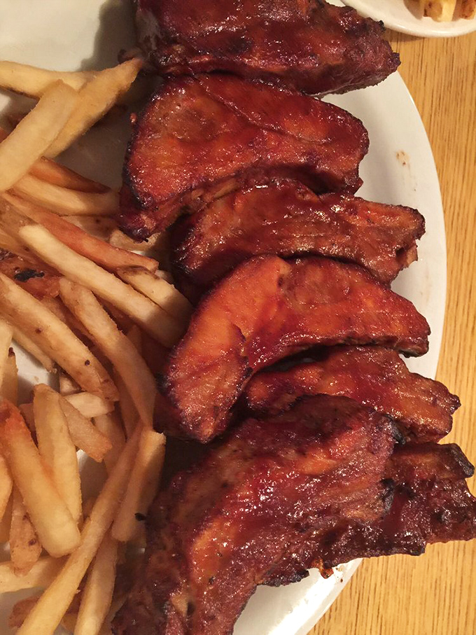 These ribs aren't falling off the bone&mdash;they're voluntarily leaving it to meet your taste buds. The kind of barbecue that makes napkins necessary and regrets impossible.