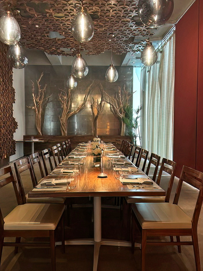 This private dining space with its sculptural ceiling and dramatic lighting turns any gathering into a special occasion worth remembering.