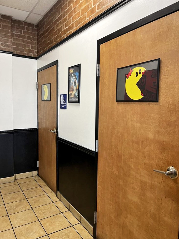 Even the restroom doors sport Pac-Man art. When a place commits this hard to nostalgia, you know they're serious about the classics.