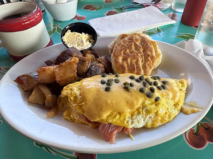 An omelet that's having an identity crisis as a work of art. Those capers aren't just garnish—they're exclamation points in a breakfast conversation.