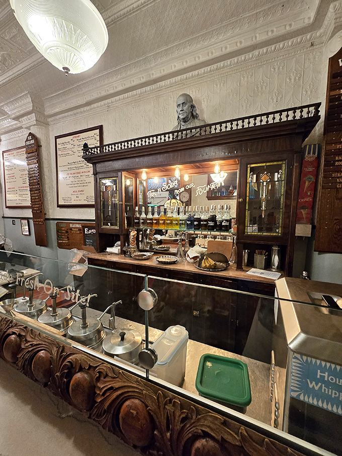 Behind this counter, magic happens daily. Franklin's bust watches approvingly as his namesake fountain continues the pursuit of happiness, one scoop at a time.