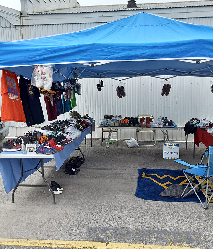 The outdoor market expands possibilities beyond four walls, with sneakers and shirts finding new life under bright blue canopies.