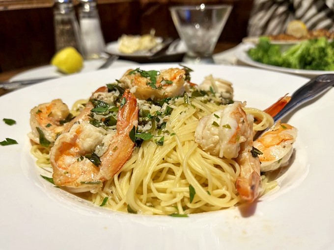 Shrimp scampi pasta where plump, perfectly cooked crustaceans lounge atop al dente noodles like sunbathers on a buttery, garlicky beach.