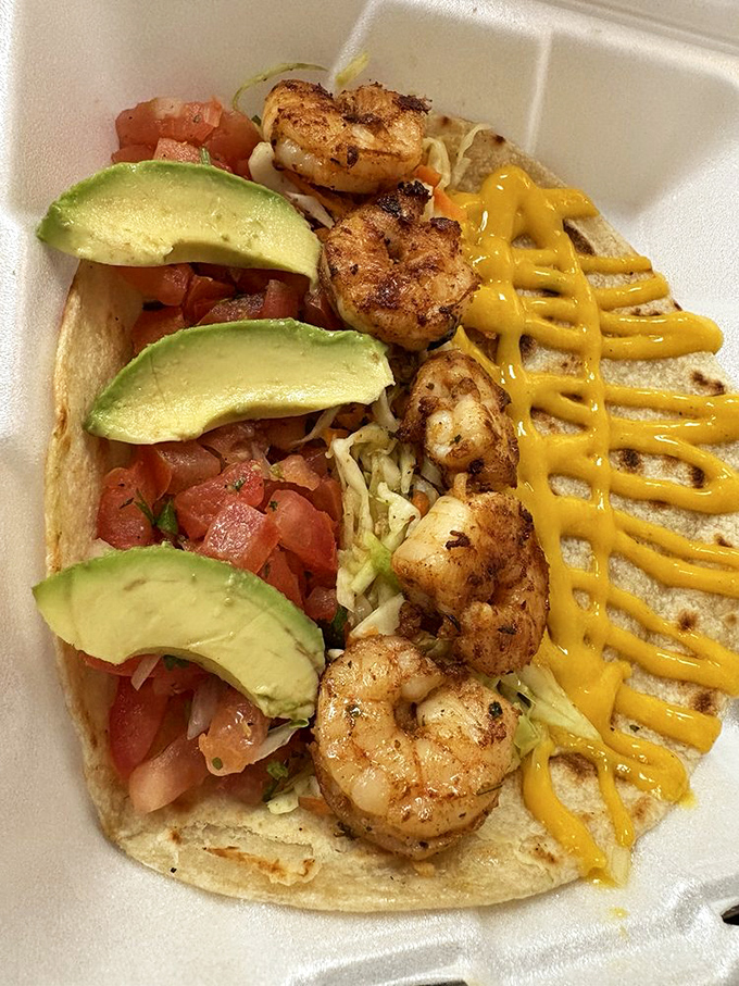 Ocean meets corn tortilla in this shrimp taco masterpiece. The yellow sauce zigzag isn't just for looks&mdash;it's the flavor highway to happiness.