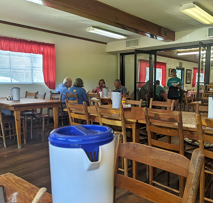 The dining room where conversations flow as freely as the sweet tea, and strangers often become friends over shared appreciation of smoke and sauce.