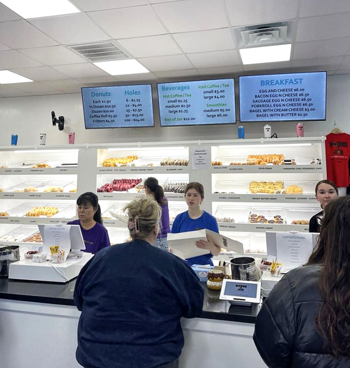 The donut transaction—a sacred exchange where money buys not just food, but a moment of pure, uncomplicated happiness in a complicated world.