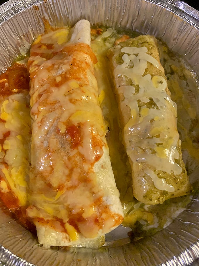 Red and green sauces create a Christmas-colored duet atop these enchiladas&mdash;proof that some gifts come wrapped in tortillas.