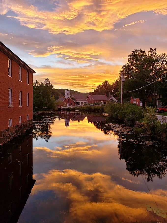 God's own light show paints Harrisville's millpond at sunset, creating the kind of moment that makes you forget what day of the week it is.
