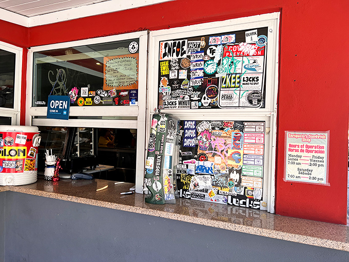 The take-out window: where sticker-covered glass separates you from sandwich nirvana, and locals know exactly what to order without hesitation.