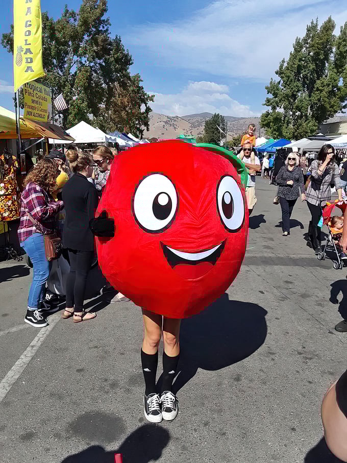 Nothing says "small-town charm" quite like a person-sized apple mascot high-fiving festival-goers with infectious enthusiasm.
