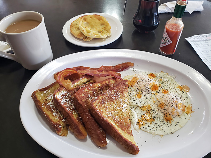 French toast that's achieved that mythical balance: crispy edges, custardy center, and enough powdered sugar to make Monday disappear.