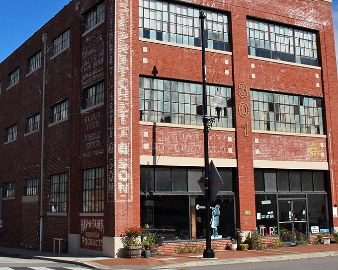 Ghost signs whisper from this repurposed warehouse's brick walls, telling tales of flour, feed, and seed while new businesses breathe fresh life inside.