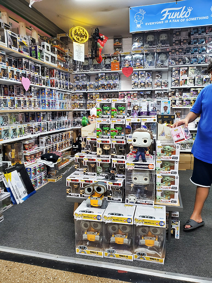 Funko Pop paradise where childhood nostalgia meets adult disposable income. Wall-E watches as wallets empty with surprising enthusiasm.