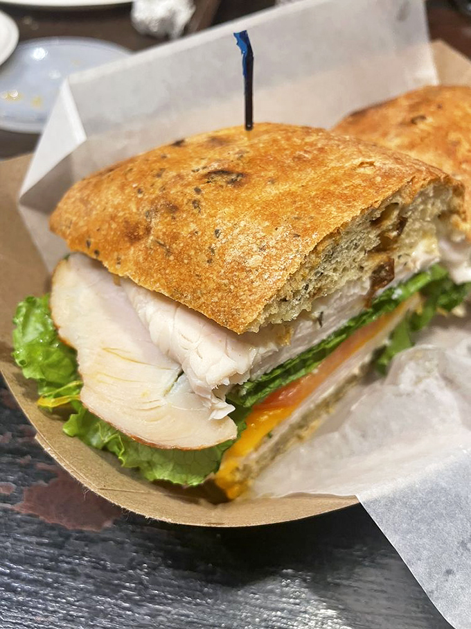 This turkey sandwich isn't just lunch – it's architectural perfection between slices of artisanal bread, a testament to simple food done right.