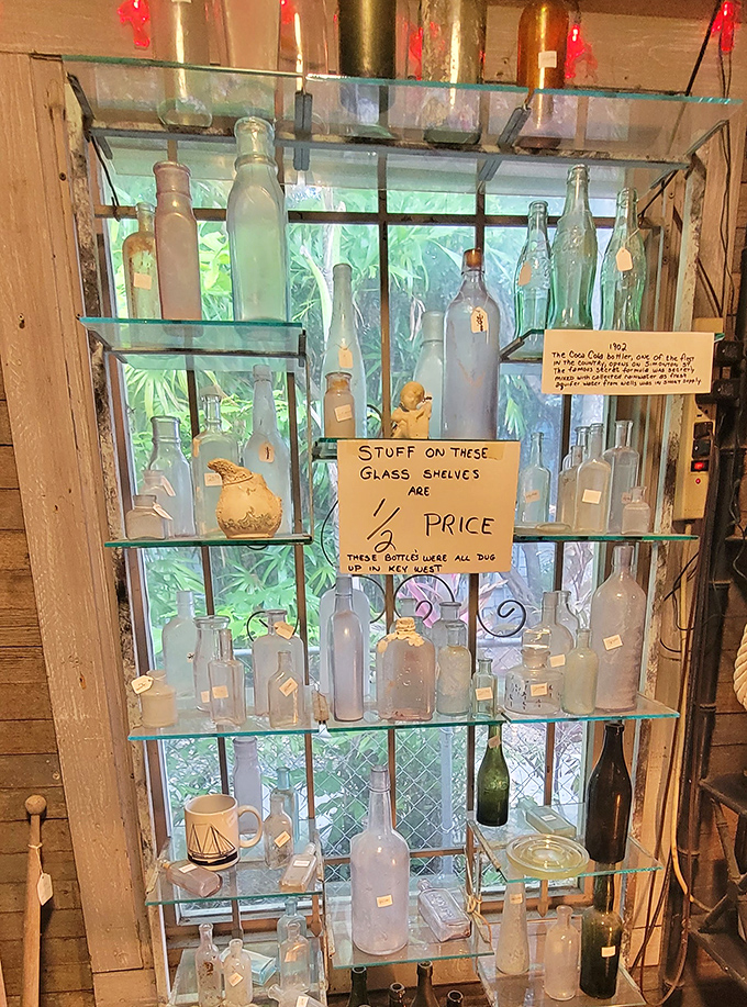 "Stuff on these glass shelves 1/2 price" announces the handwritten sign among bottles excavated from Key West soil &ndash; each one containing ghosts of island history.