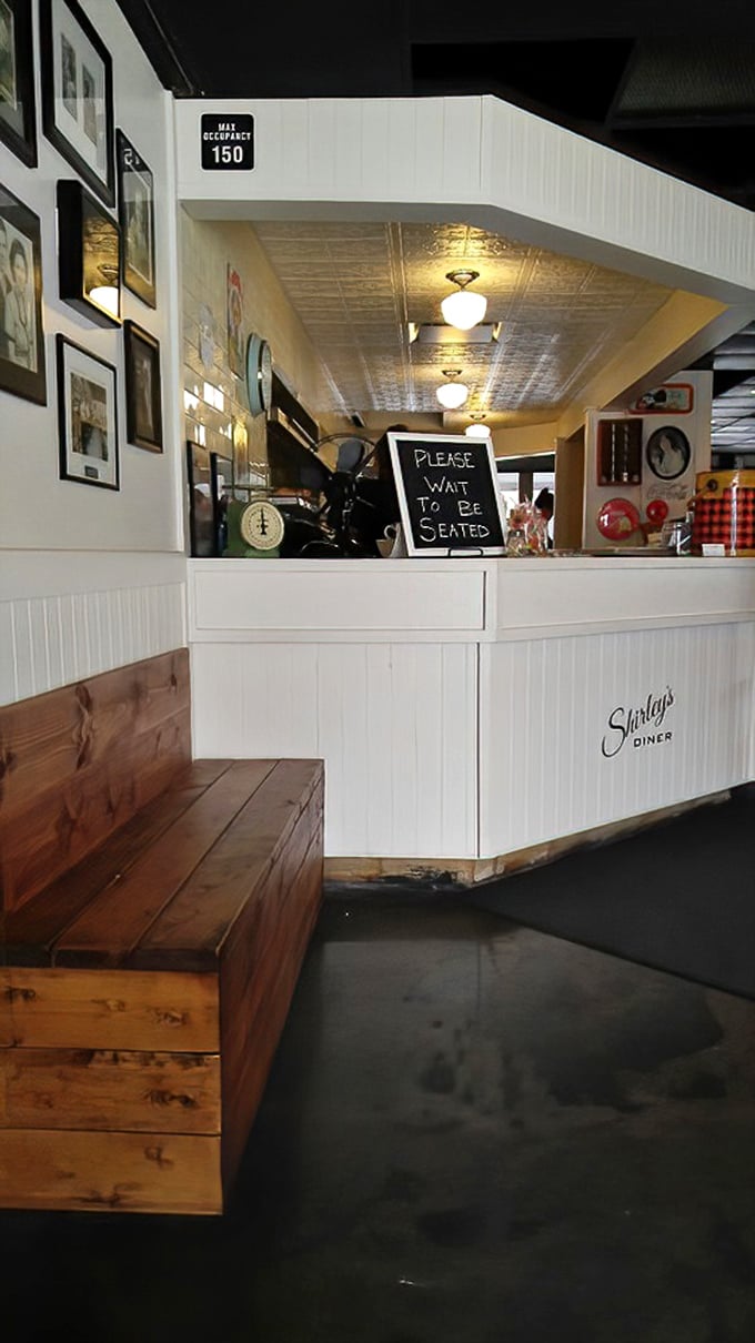 "Please Wait To Be Seated" reads the sign, but the rustic wooden bench makes the brief anticipation feel like part of the experience.