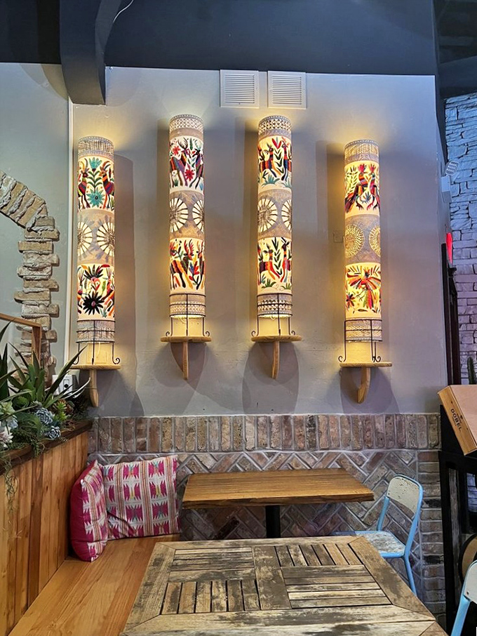 These illuminated wall panels tell stories of Mexican folk art while casting a warm glow that makes everyone look like they're on vacation.