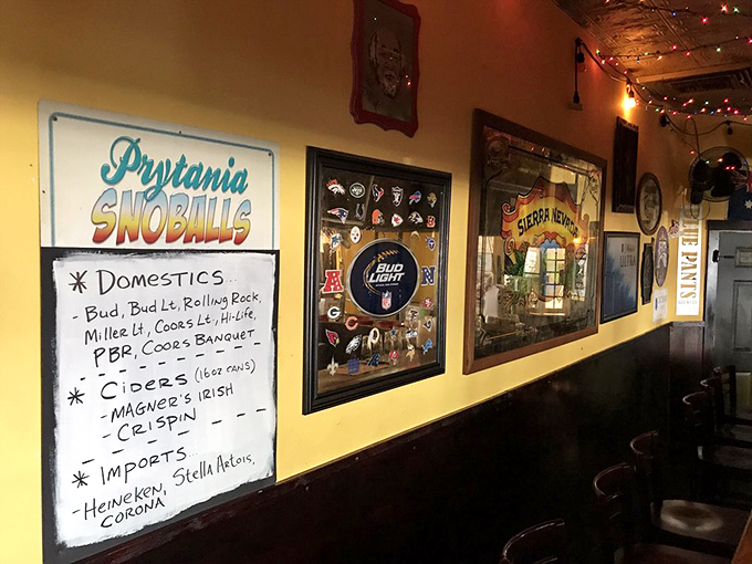 The wall doesn't just display beverages&mdash;it tells stories. "Prytania Snowballs" sign hints at sweet treats while the beer selection promises proper thirst-quenching adventures.