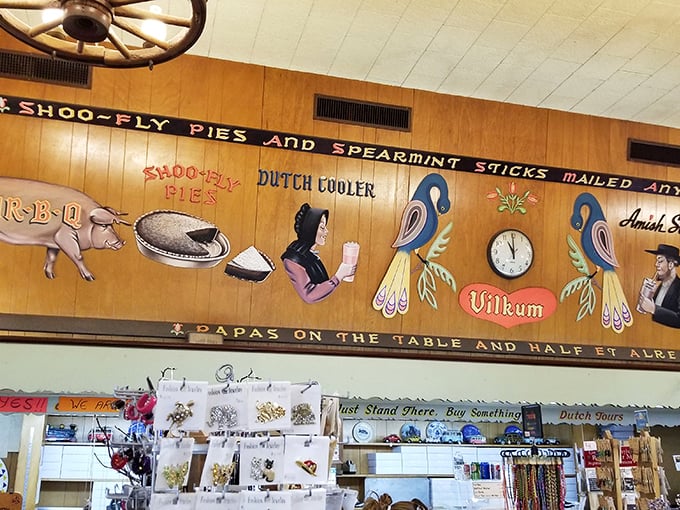 Whimsical Pennsylvania Dutch folk art adorns the walls, telling stories of heritage with colorful birds and horse-drawn plows above merchandise displays.