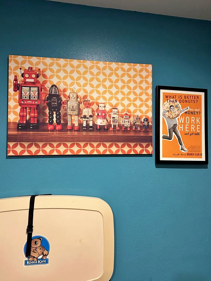 Wall art that winks at you while you eat, featuring vintage robots and a philosophical question about donuts versus money.