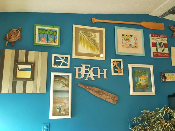 The wall art says "BEACH" but the vibe says "stay awhile." Coastal charm meets homey comfort in this delightful decor that captures Florida's laid-back spirit.