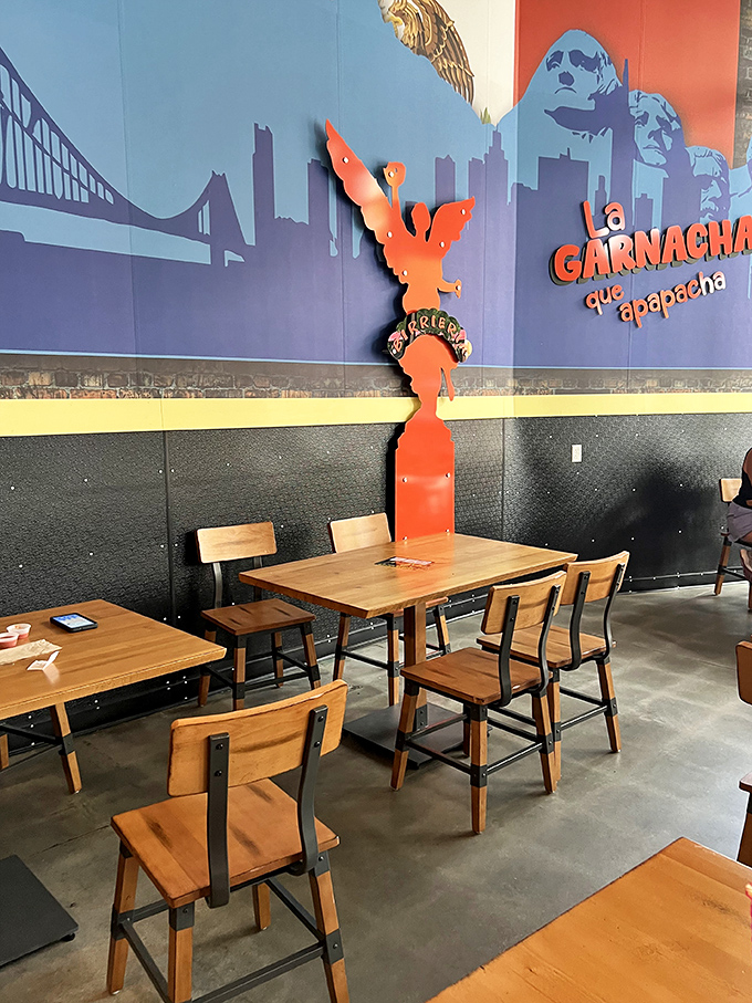 The wall art tells you everything: this place bridges cultures through food. That orange angel statue isn't subtle, but neither are the flavors.
