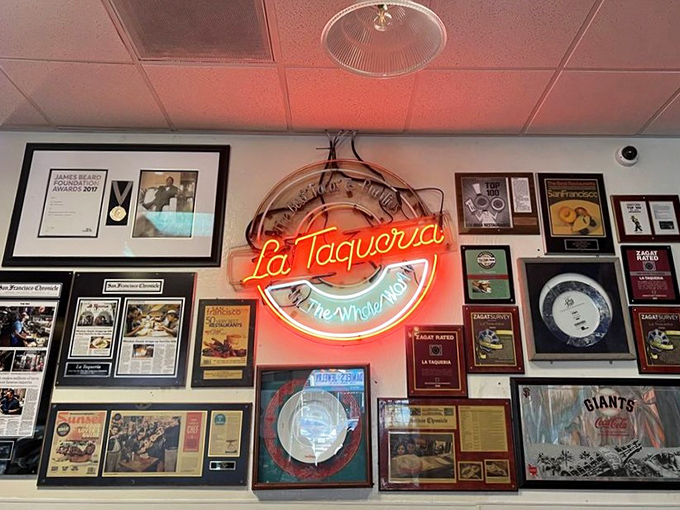 The wall of fame tells a story of culinary excellence. Each framed accolade represents another food lover who discovered what locals always knew.