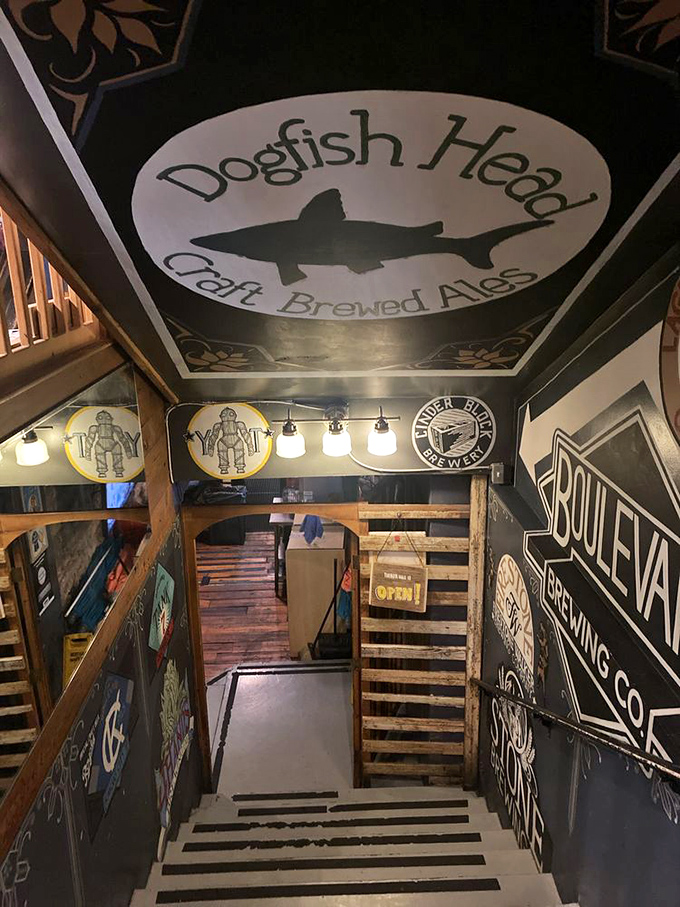 The stairway to burger heaven is decorated with craft beer logos—a preview of the flavor adventure awaiting below.