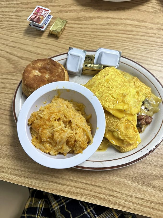 Breakfast that doesn't understand the concept of moderation. This omelet, hash browns, and biscuit combo is why elastic waistbands were invented.