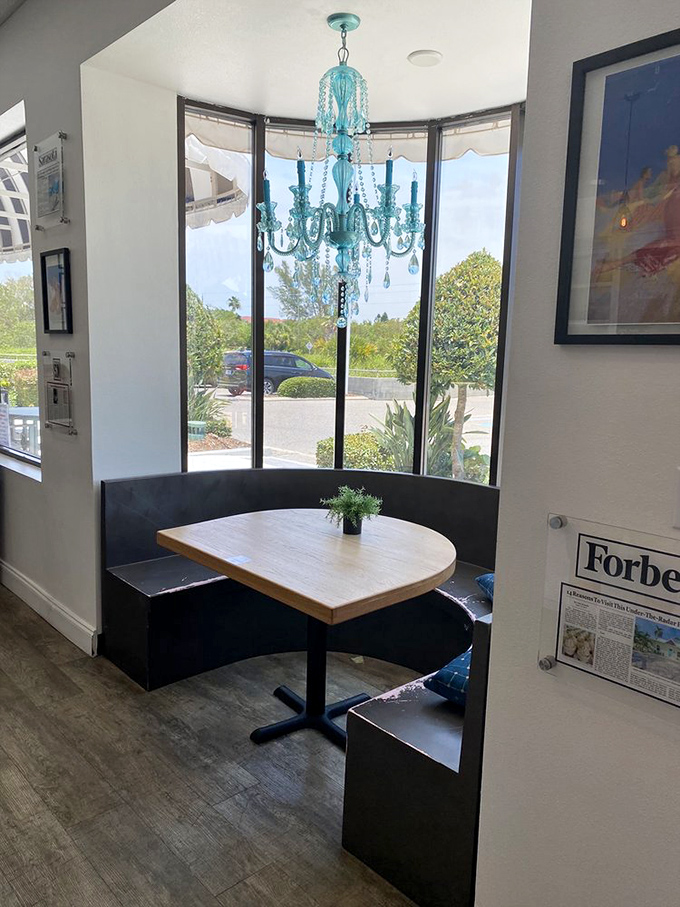 That turquoise chandelier hanging over the corner booth is giving serious "mermaid's dining room" vibes—and I'm here for it.