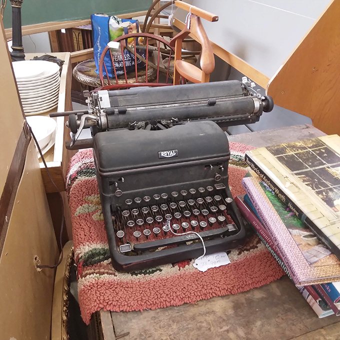 A vintage Royal typewriter sits silently, keys that once clacked out love letters and business memos now a monument to pre-digital communication.