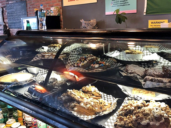 Behind glass lies a treasure trove of sweet temptations. The dessert case: where willpower goes to negotiate its surrender terms.