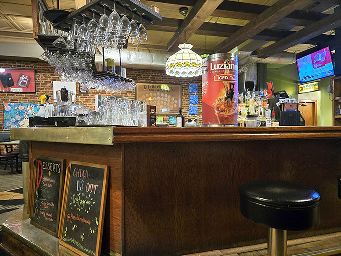The bar area beckons with the promise of cold drinks and warm conversation—a neighborhood gathering spot where everybody might not know your name yet, but they will.