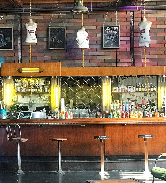 The bar channels vintage speakeasy vibes with its warm wood, mirrored backdrop, and hanging tank tops that hint at The Duce's boxing heritage.