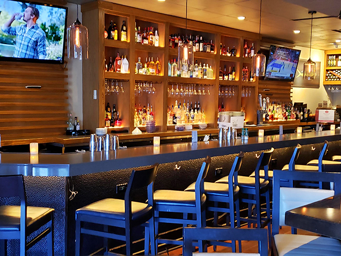 A bar that beckons with amber-lit bottles and comfortable seating &ndash; where "just one drink" often turns into dinner and dessert.