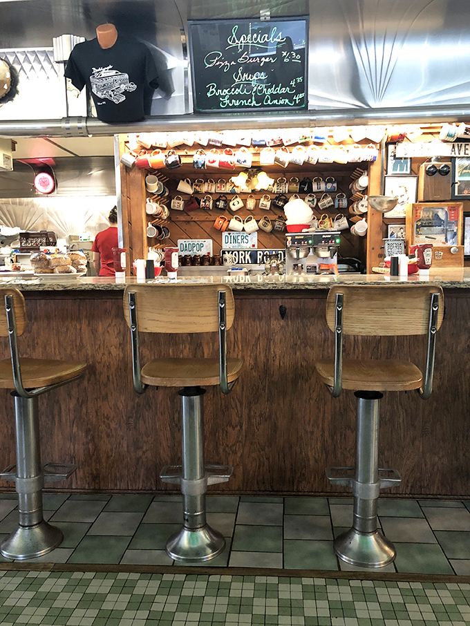 The counter—where solo diners become regulars, coffee cups are never empty, and the collection of mugs tells stories of diners past.