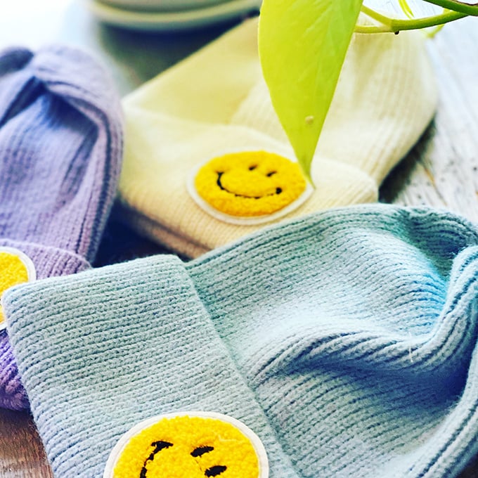Happy faces on these beanies mirror the expressions of shoppers who score them for a steal. Cozy style that makes winter almost worth it.