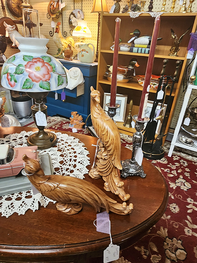 Carved wooden birds perch elegantly on this antique table, ready to migrate to someone's mantel. Nature-inspired decor from a more handcrafted era.