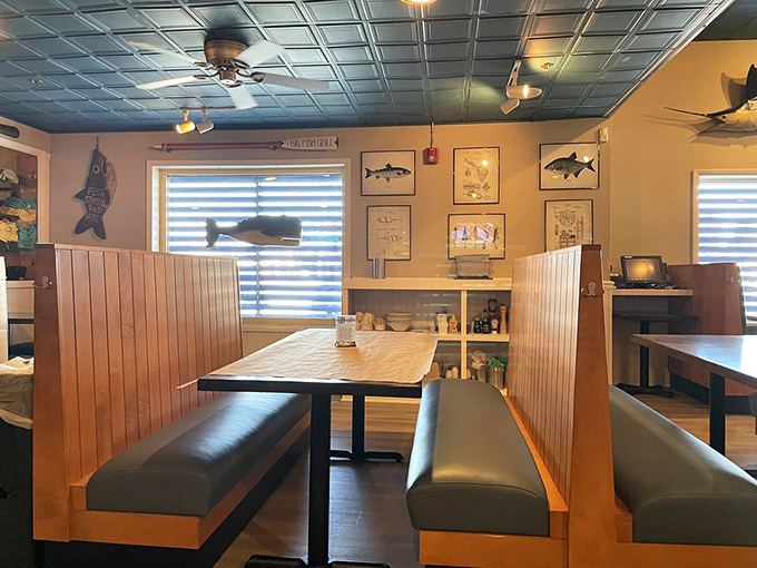 Cozy booth seating where fishing diagrams on the wall remind you exactly why you're about to order something with fins.